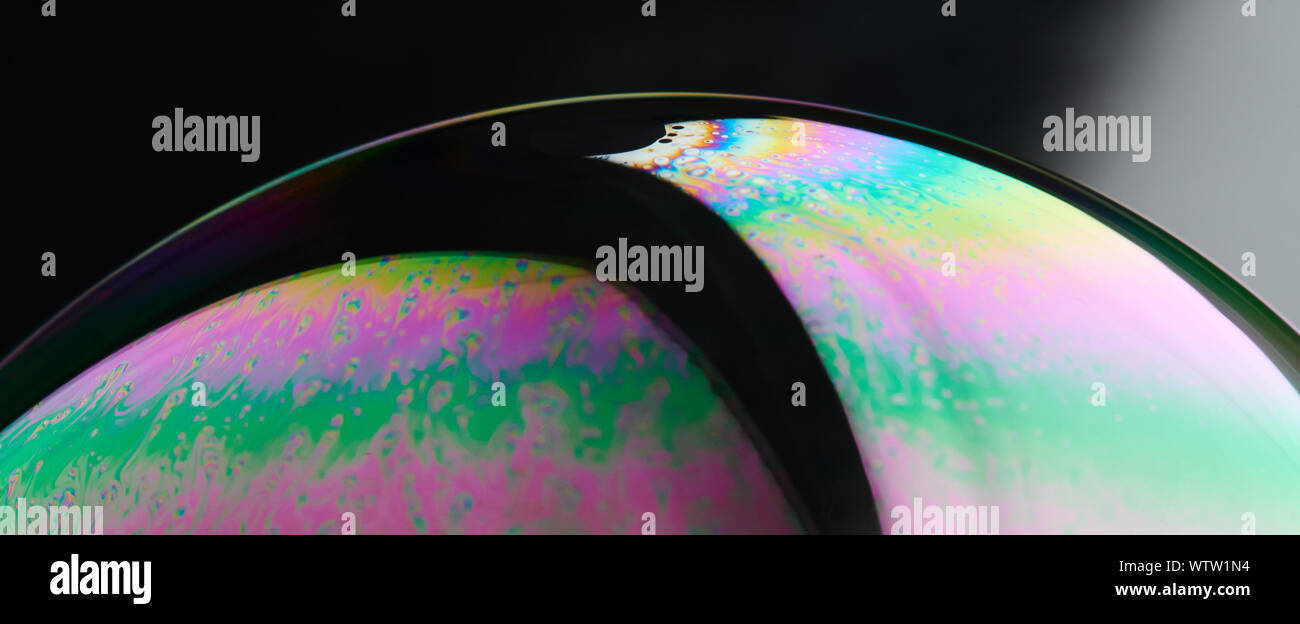 Colorful soap bubble texture on black background close up view Stock ...