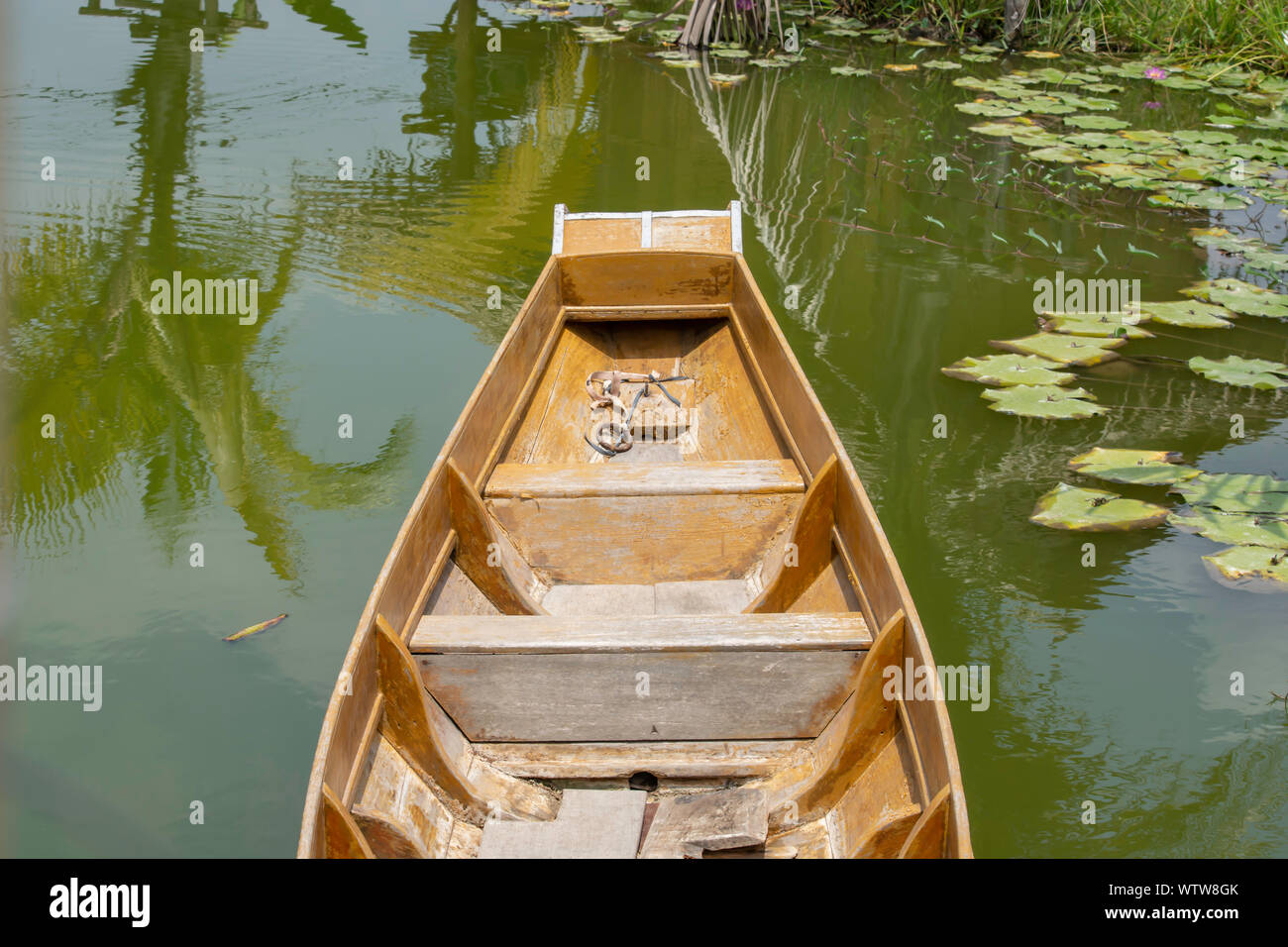 The boat made of wood floating on the water in the lotus pond Stock ...
