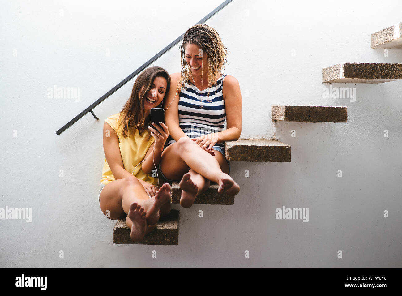 Barefoot woman sitting on stairs hi-res stock photography and images ...