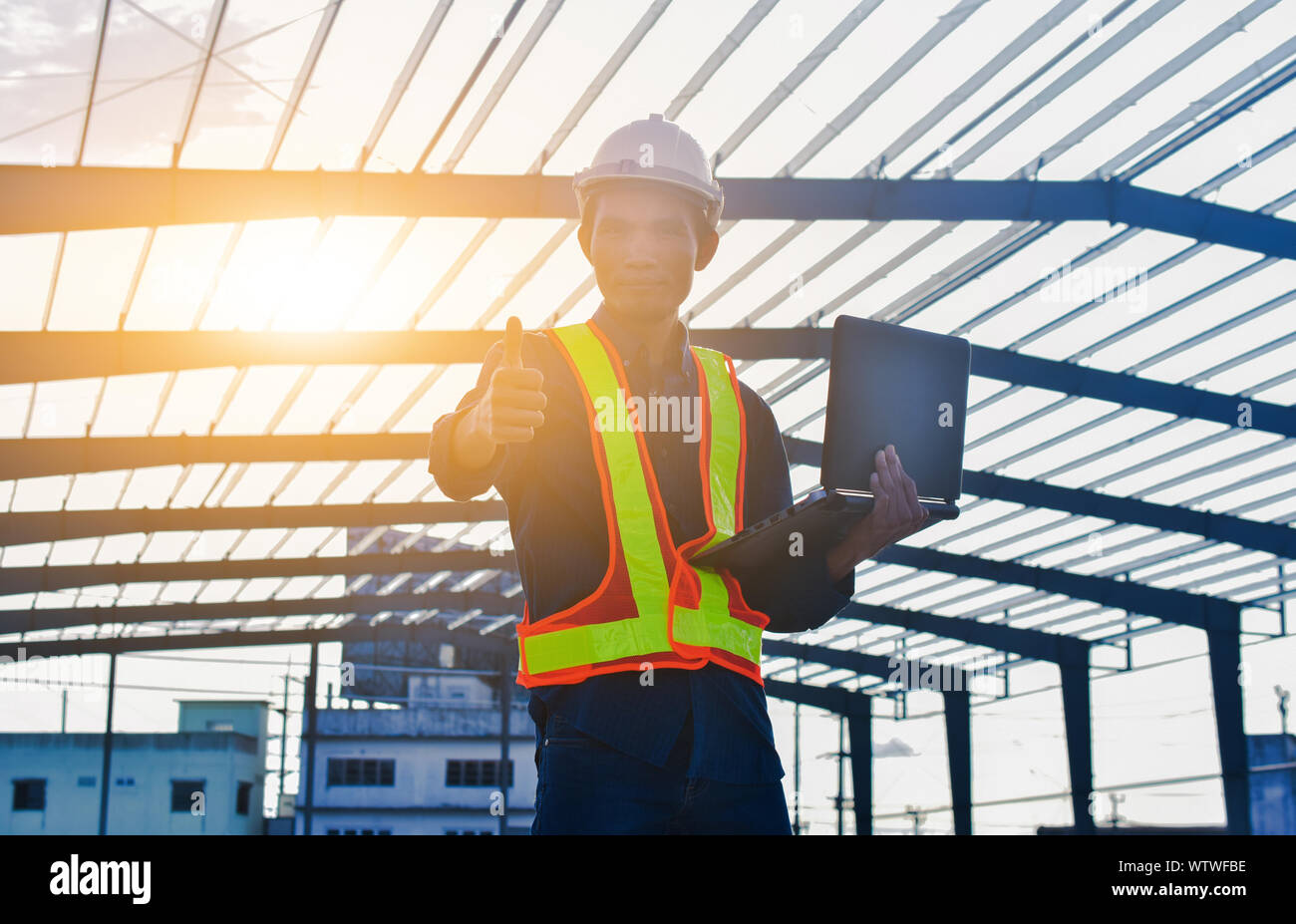 Engineer holding computer working on side technology Building ...
