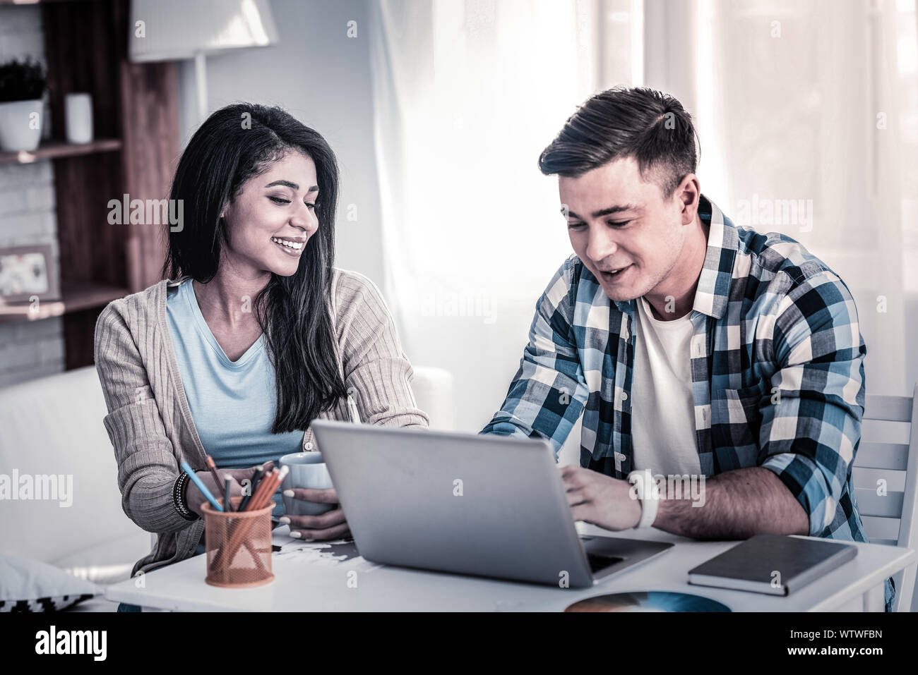 International couple having sweet conversation during morning routine ...