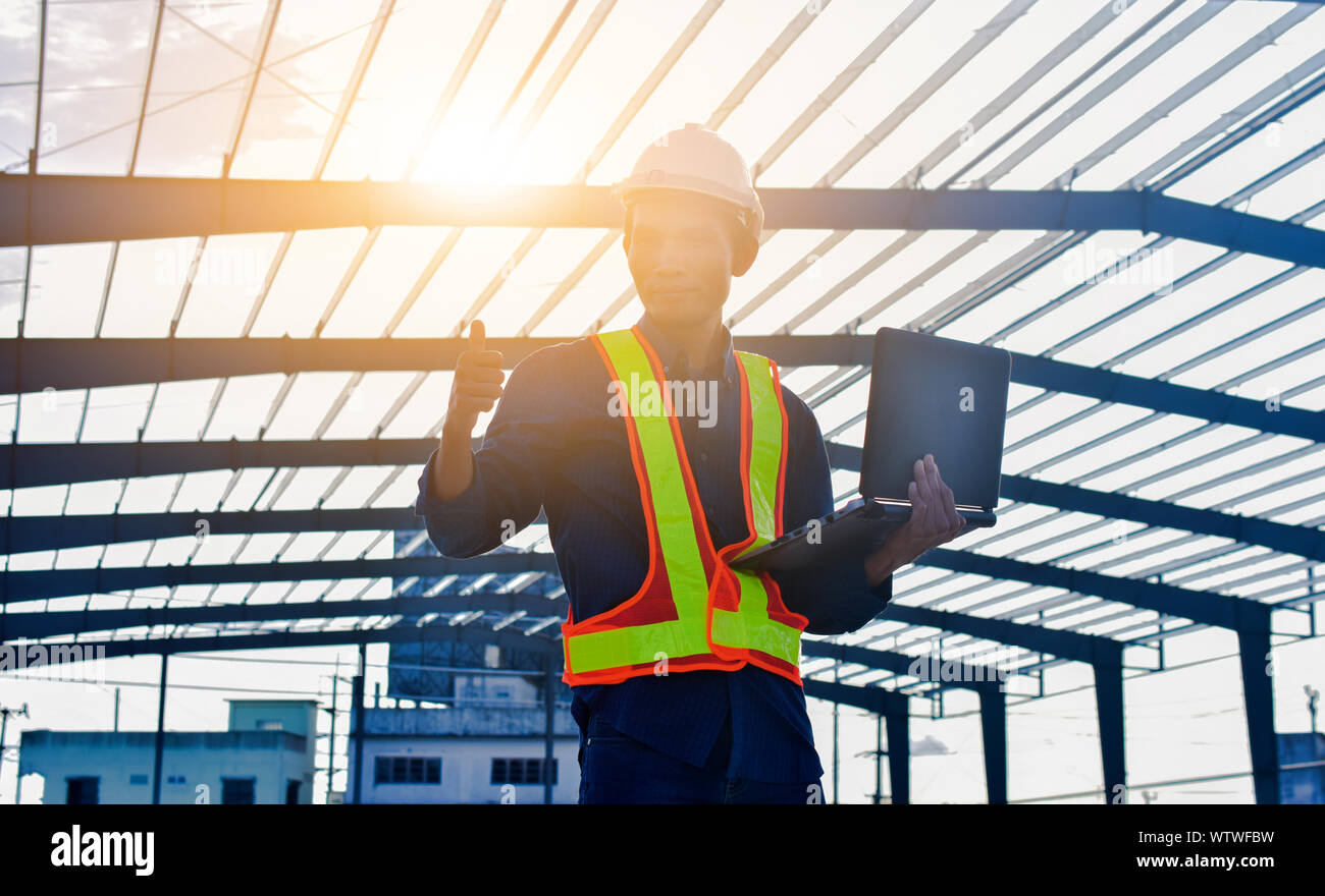 Engineer holding computer working on side technology Building ...