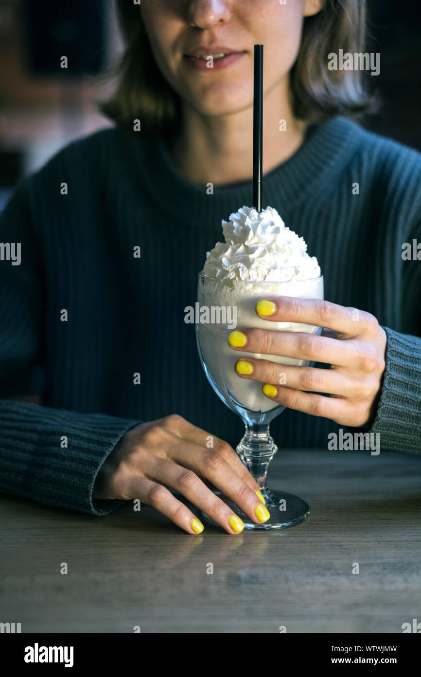 Young Woman Drinking Milkshake in cafe Stock Photo - Alamy