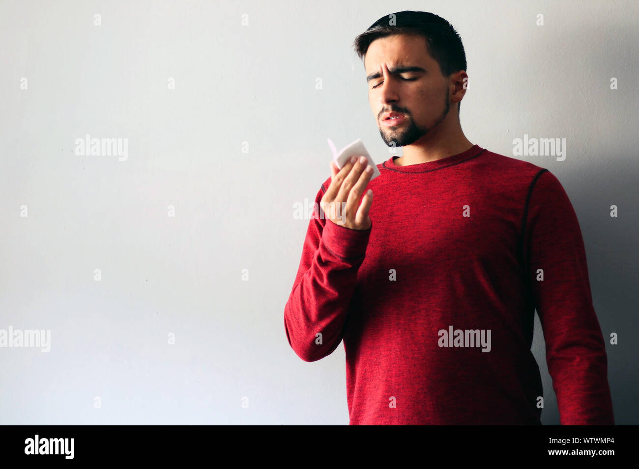 Medicine and health concept: Young man coughing and covering mouth with ...