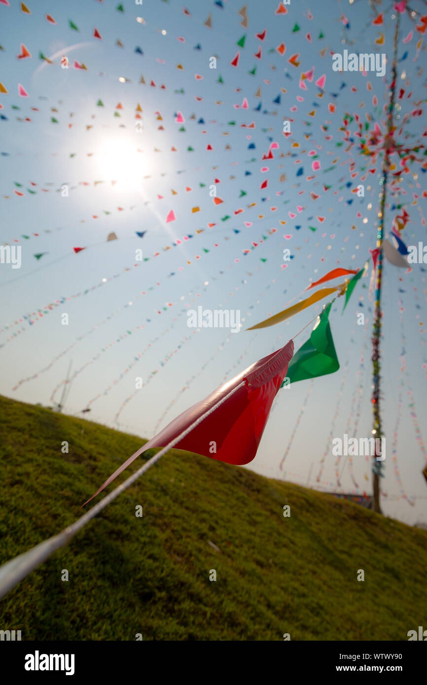 Multi-color triangle pray flags at Thai celebration festival with cloud ...