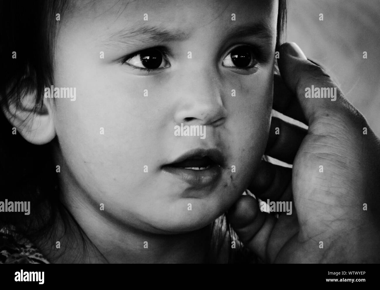 Cropped Hand Touching Girl Face Stock Photo - Alamy