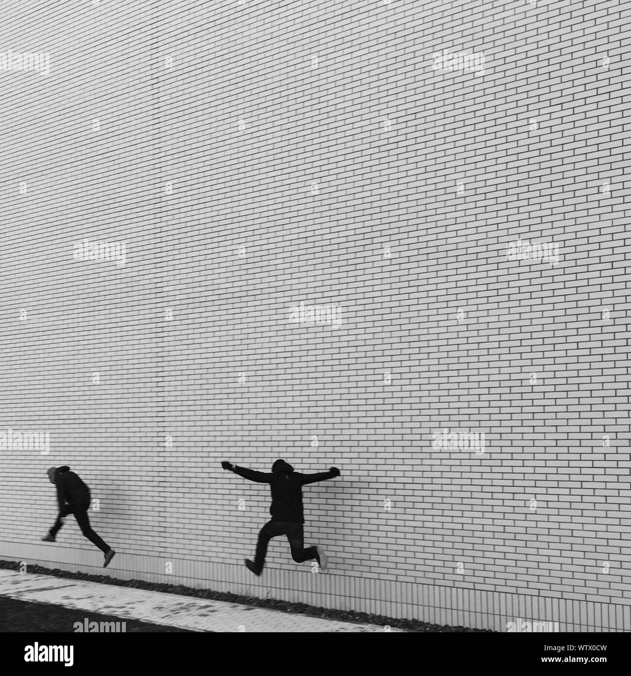 Jumping brick wall Black and White Stock Photos & Images - Alamy