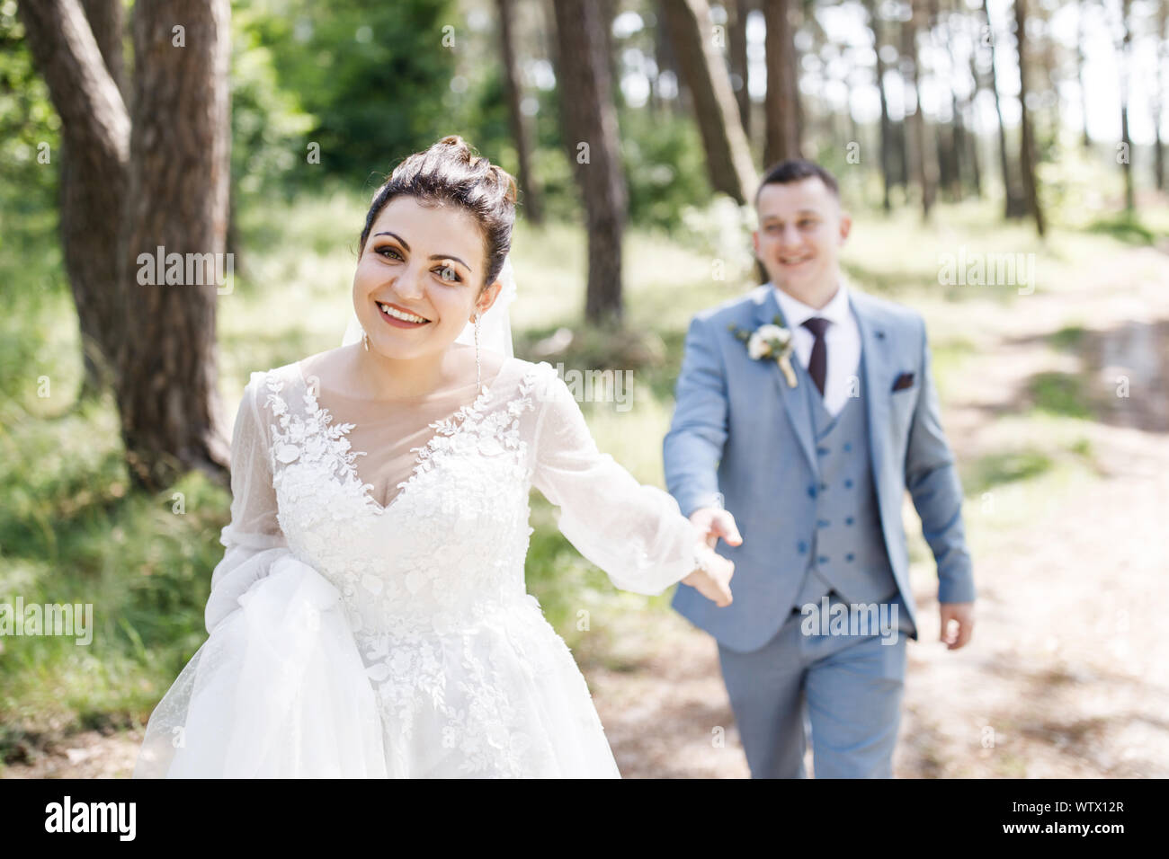 The bride and groom have fun outdoors on their wedding day Stock Photo ...