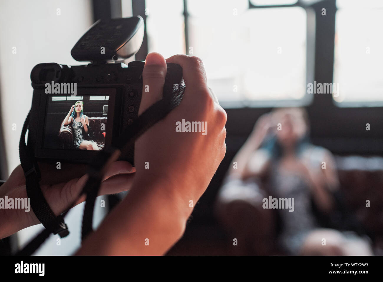 Close-up of hand holding camera. Mirrorless camera close up in the hand ...