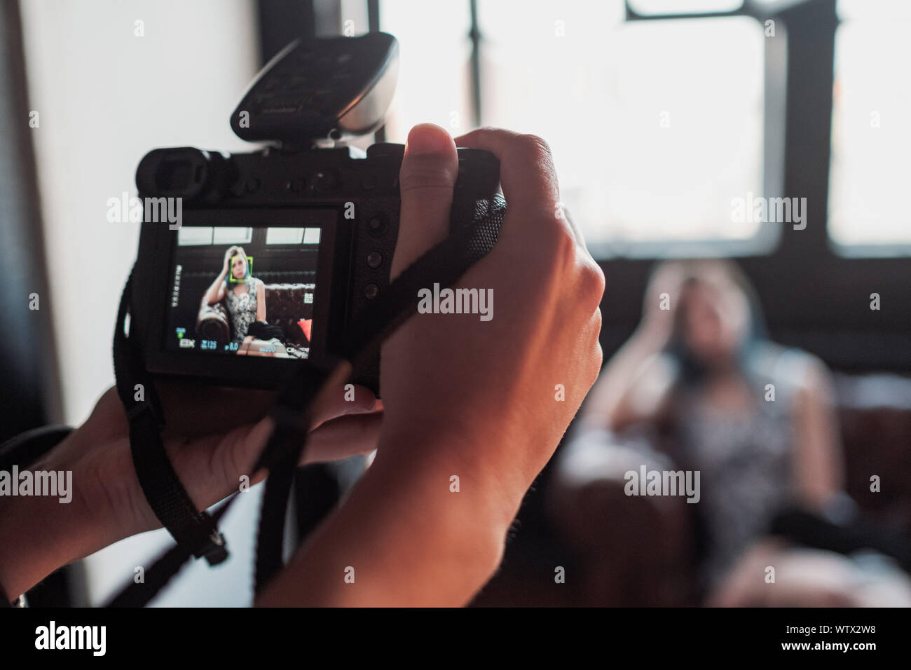 Close-up of hand holding camera. Mirrorless camera close up in the hand ...