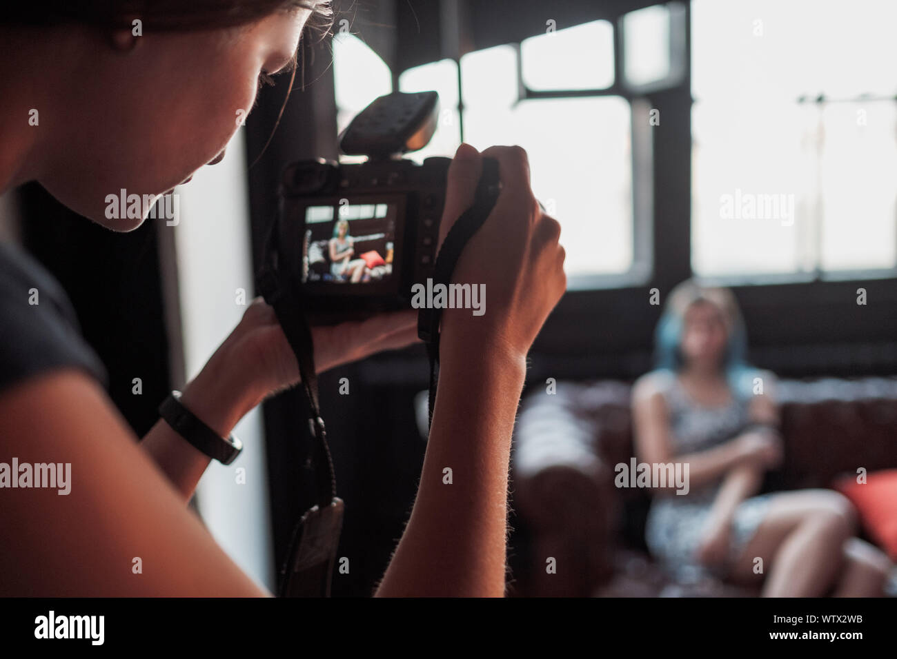 Close-up of hand holding camera. Mirrorless camera close up in the hand ...