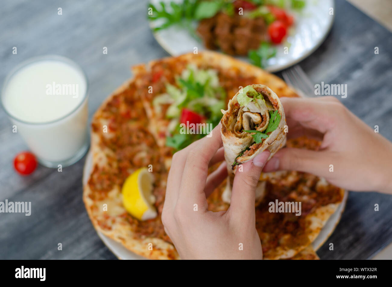 Traditional delicious Turkish food; Turkish lahmacun.top view.The boy ...