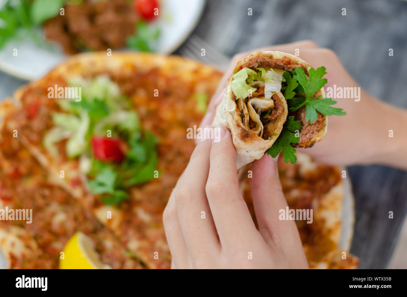Traditional delicious Turkish food; Turkish lahmacun.top view.The boy ...