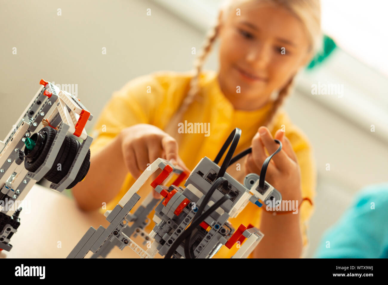 Girl figuring out how to fix her science project Stock Photo - Alamy