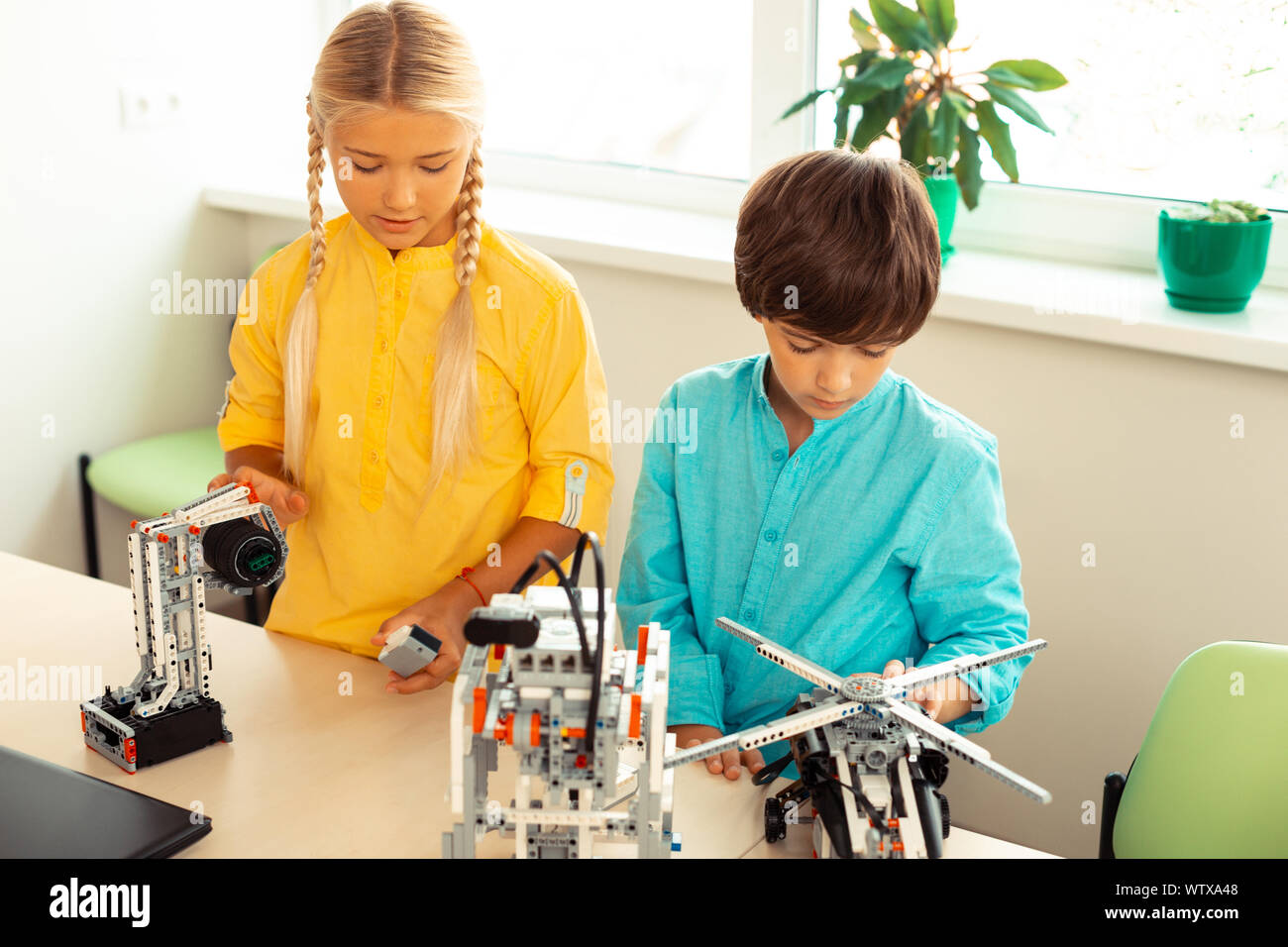 Stem education. Children building robots in classroom Stock Photo - Alamy