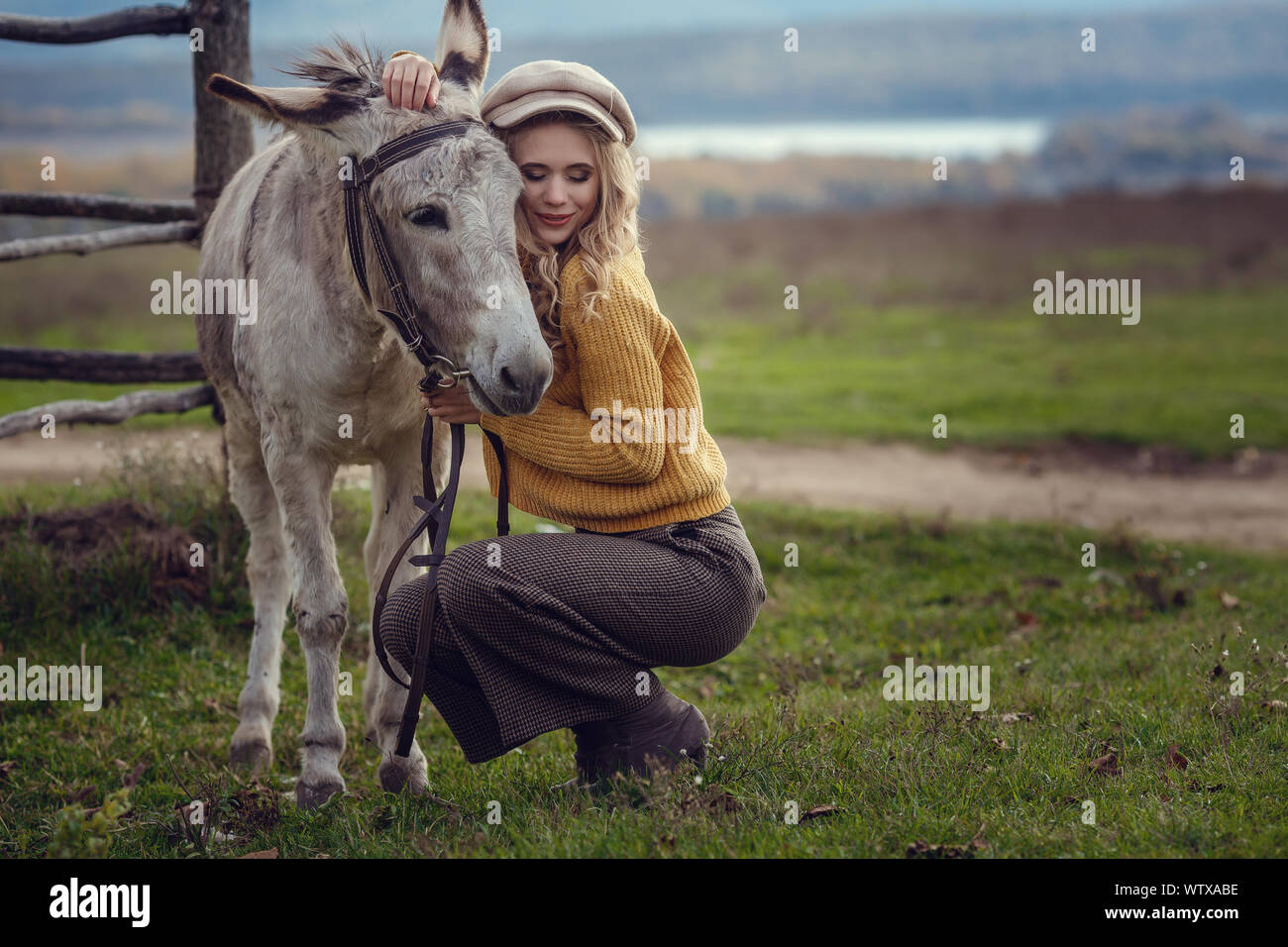 A girl with blond hair in fashionable clothes in the style of Provence ...