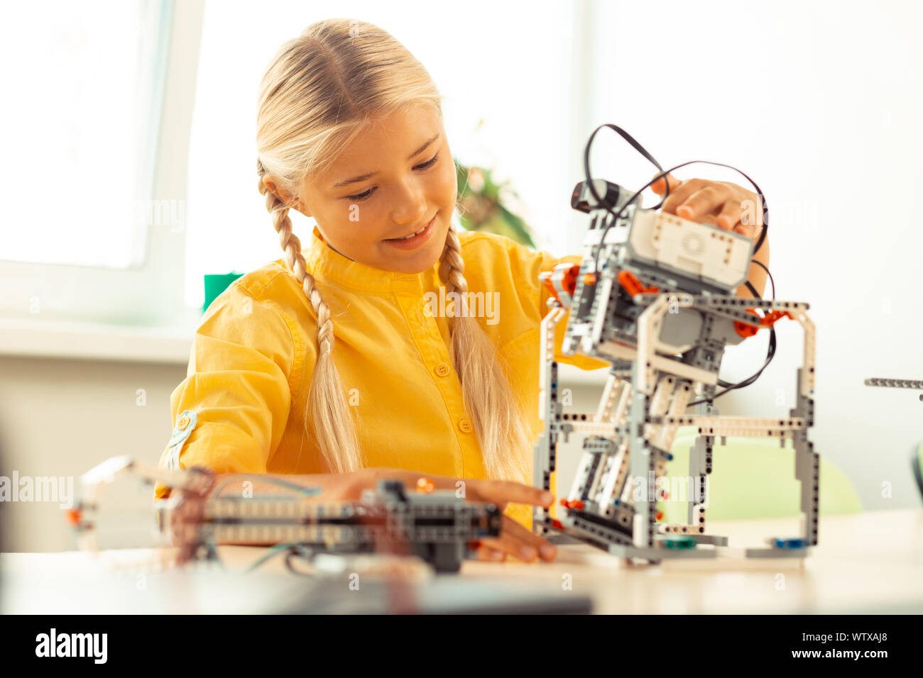 Girl playing with a robot at science lesson Stock Photo - Alamy