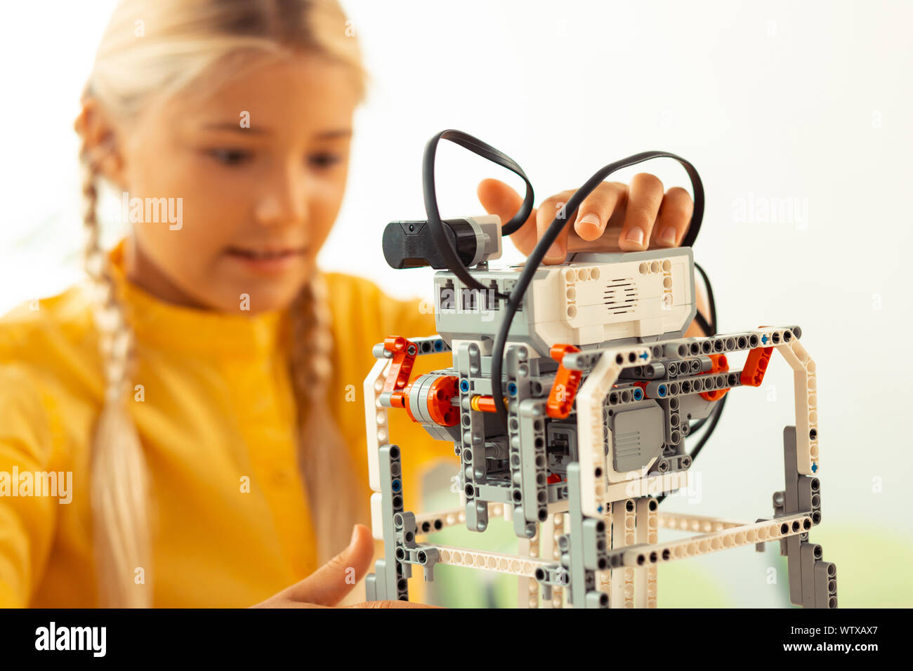 Schoolgirl working with a robot model at the lesson Stock Photo - Alamy
