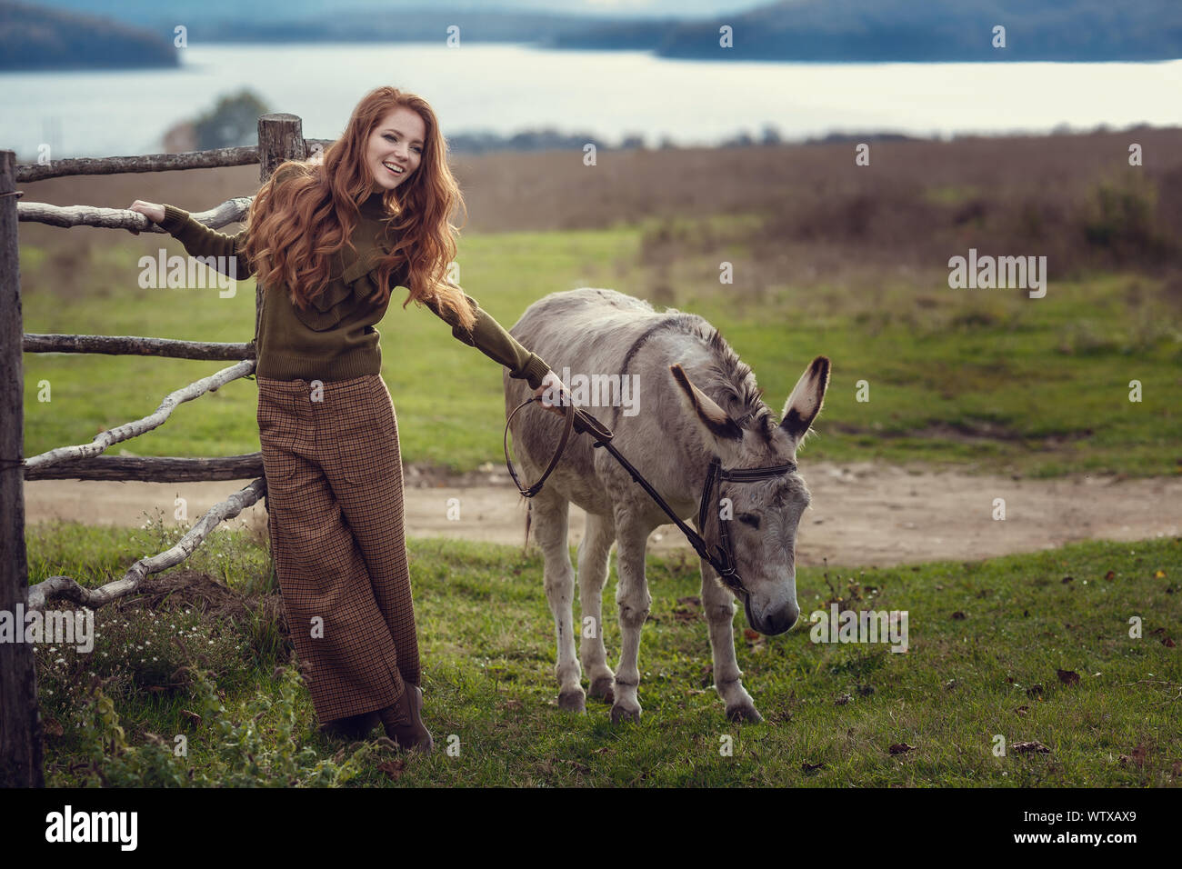 A girl with curly red hair in fashionable clothes in the style of ...