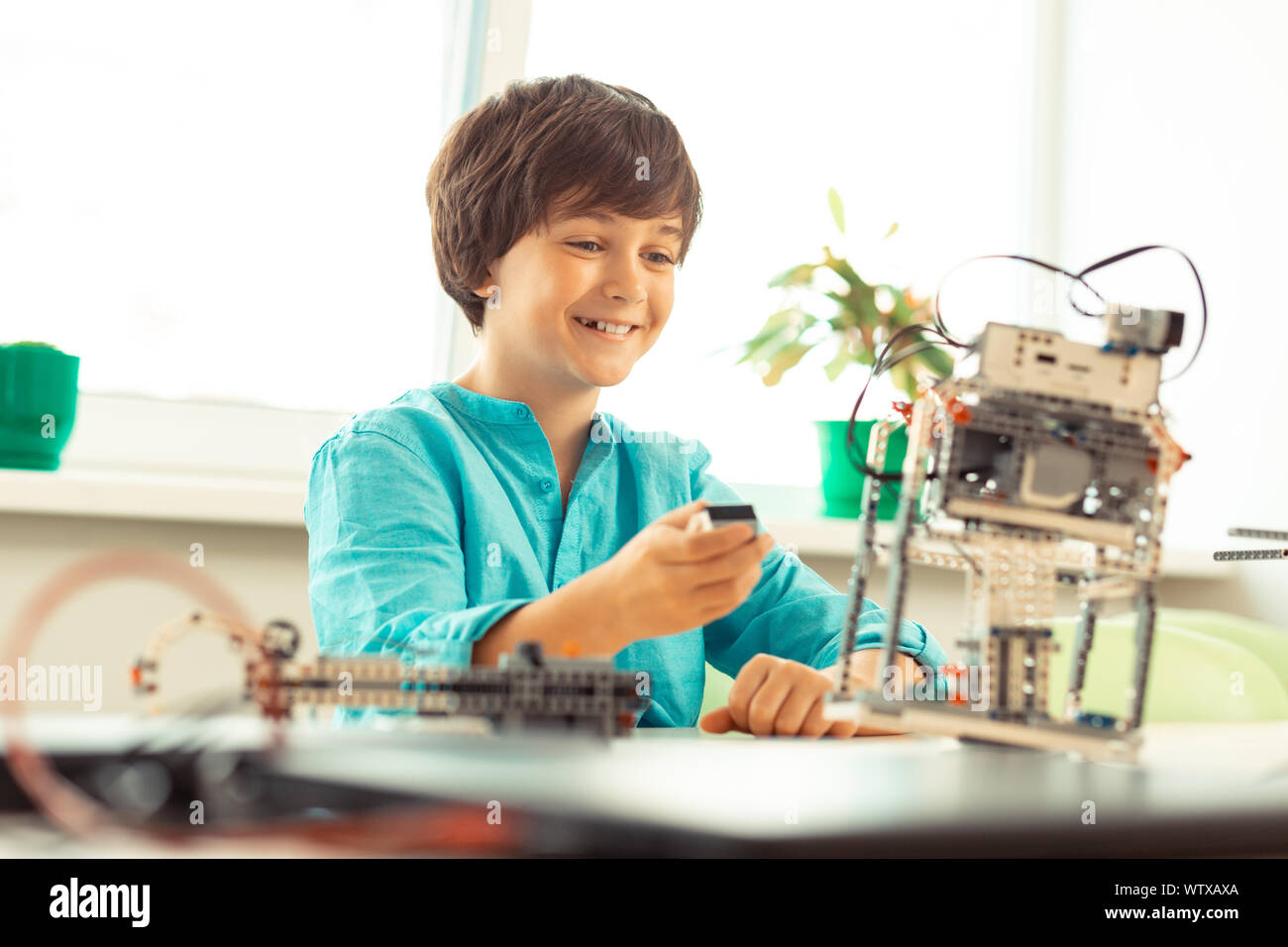 Cheerful boy being happy trying his robot model Stock Photo - Alamy