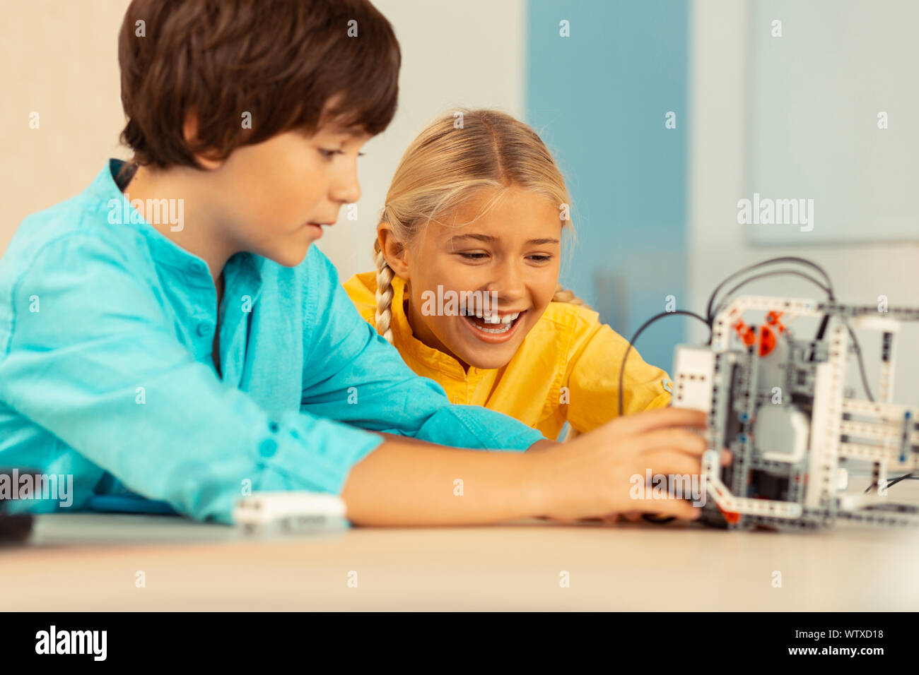 Schoolchildren being happy playing with a robot Stock Photo - Alamy