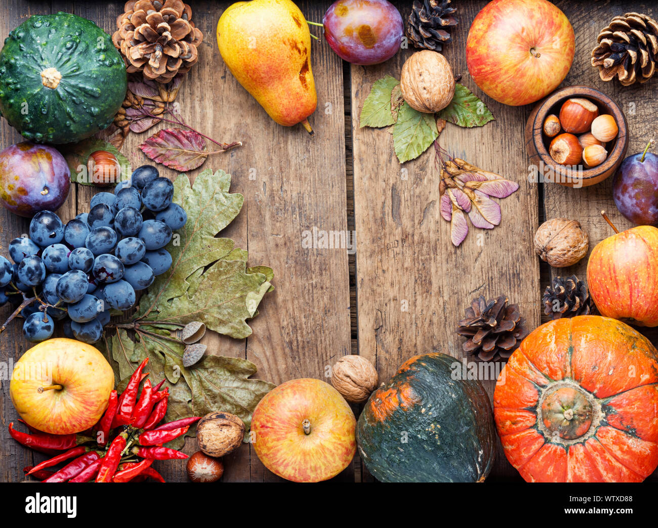 Pumpkins,nut and fruits in autumn still life on wooden table.Fall still ...