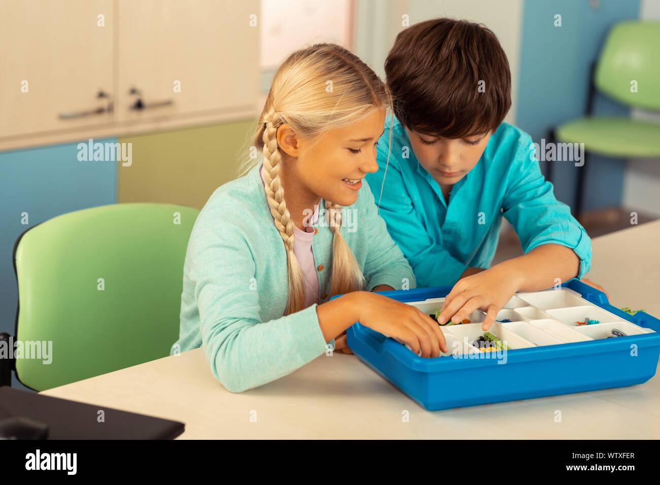 Boy and girl looking for details before building Stock Photo - Alamy