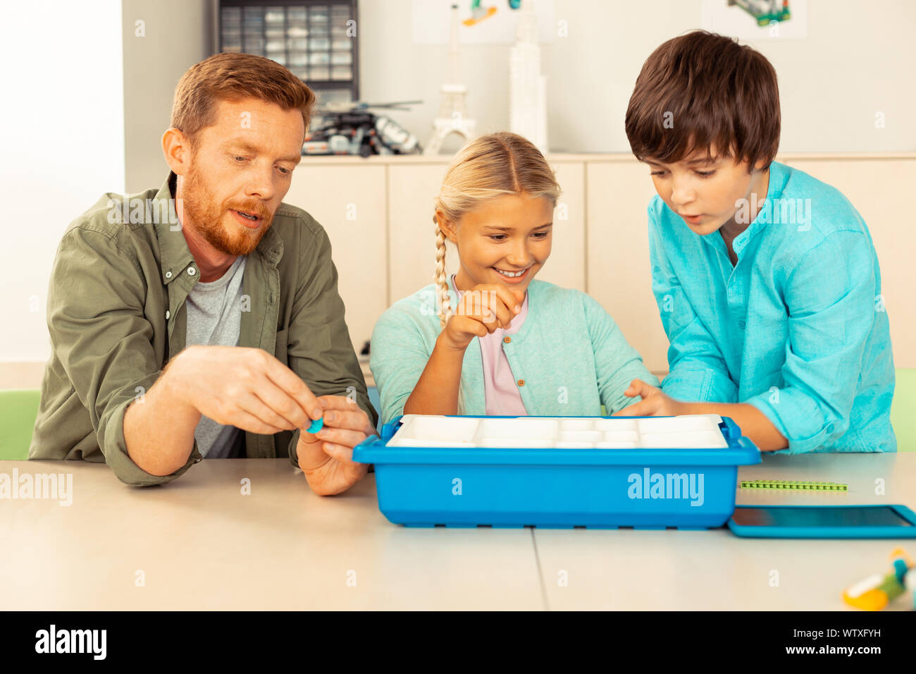 Science teacher giving a task to his pupils Stock Photo - Alamy