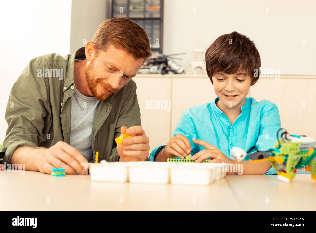Science teacher building a house with a pupil Stock Photo - Alamy