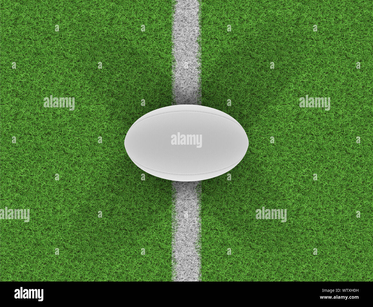 A top view of a white textured rugby ball on a grass pitch with ...