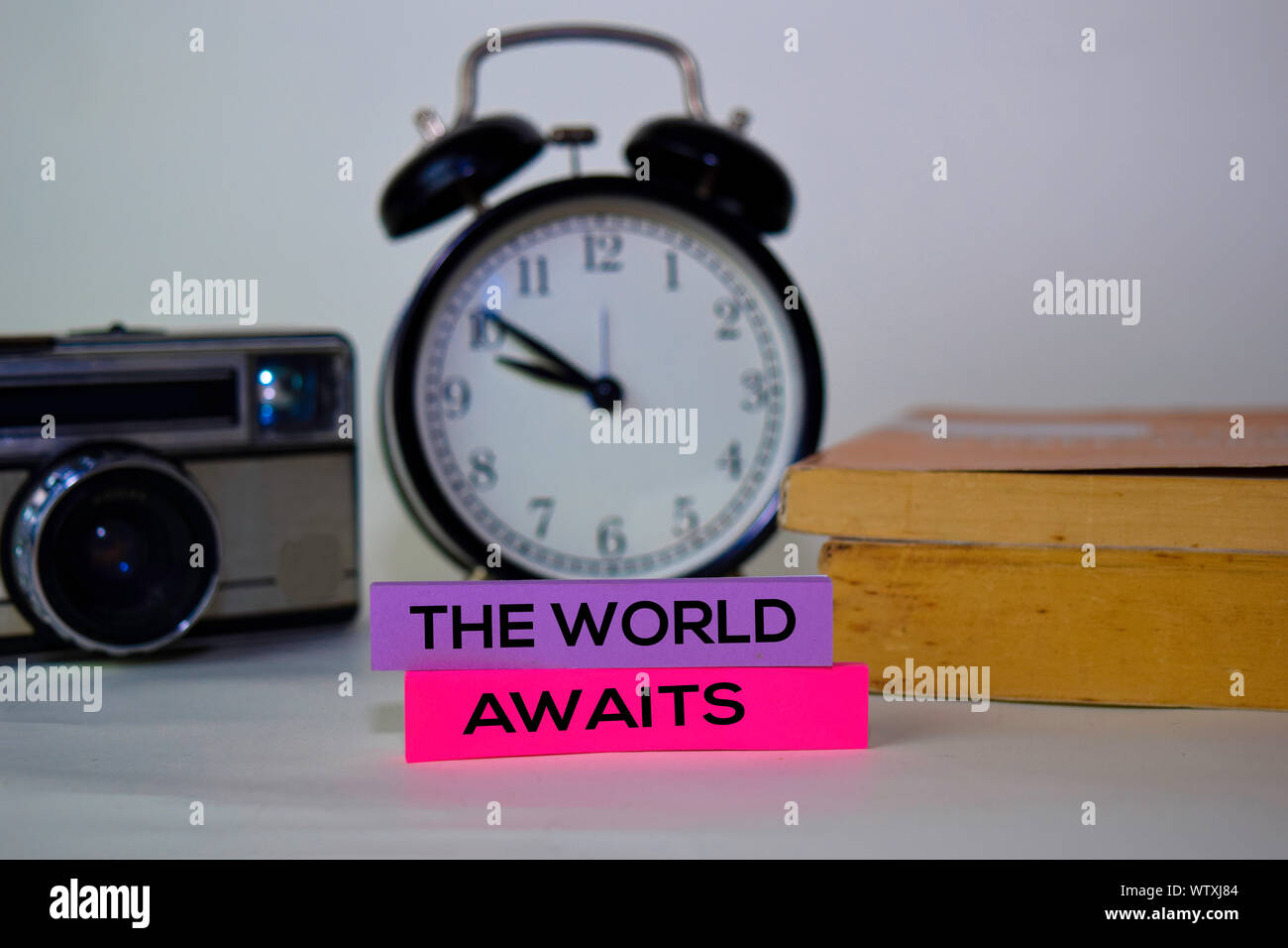 The World Awaits text on sticky notes isolated on desk background Stock ...