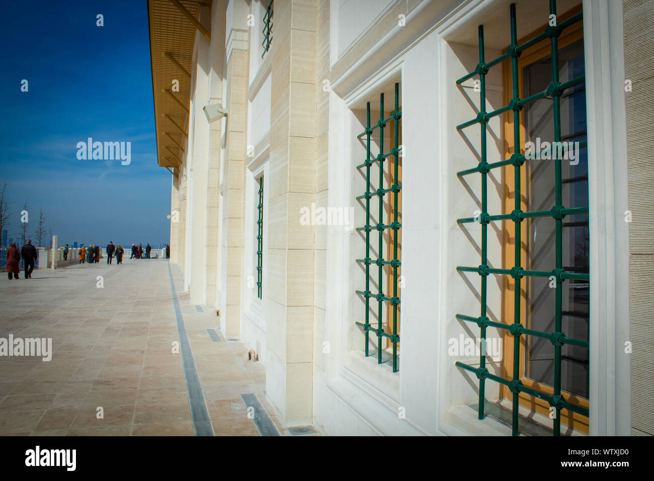 Detail of white building and green decorative metal railing window ...