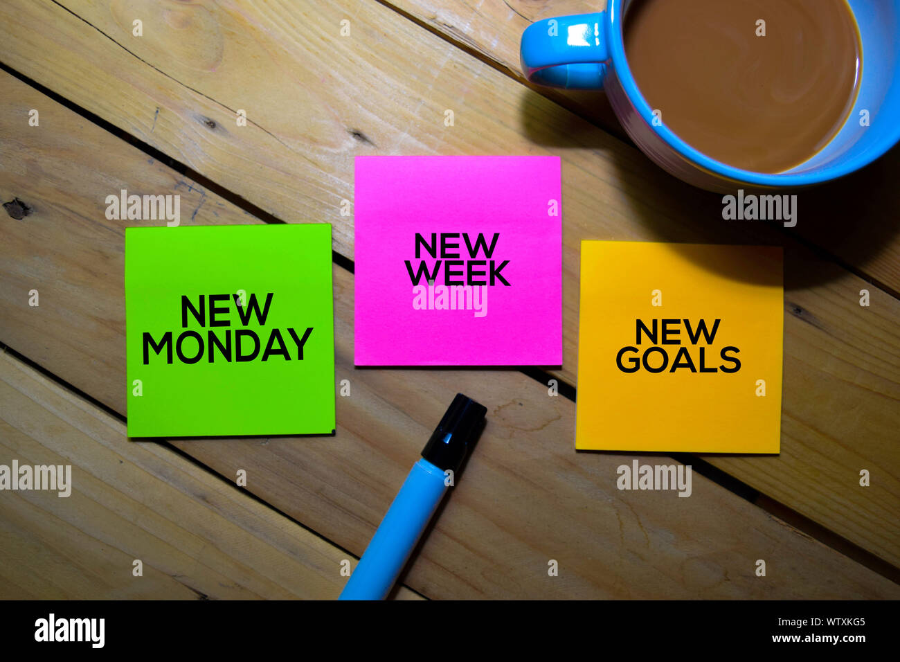 New Monday New Week New Goals text on sticky notes isolated on table ...