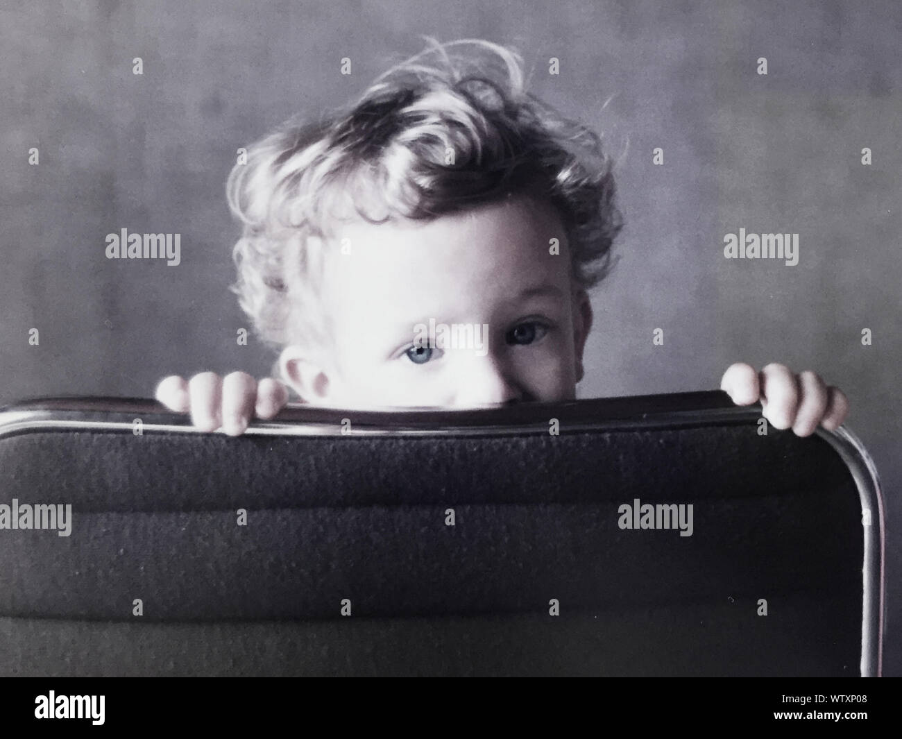 Boy by chair hi-res stock photography and images - Alamy