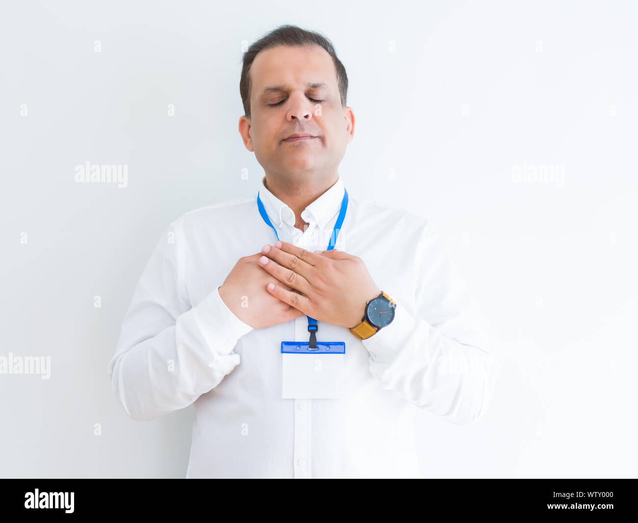 Middle age business man wearing ID card over white background smiling ...