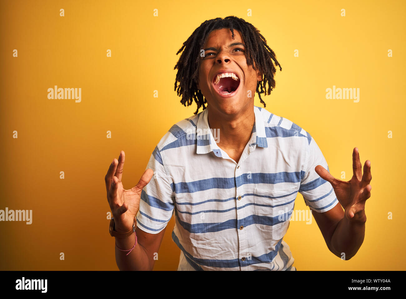 Afro american man with dreadlocks wearing striped shirt over isolated ...