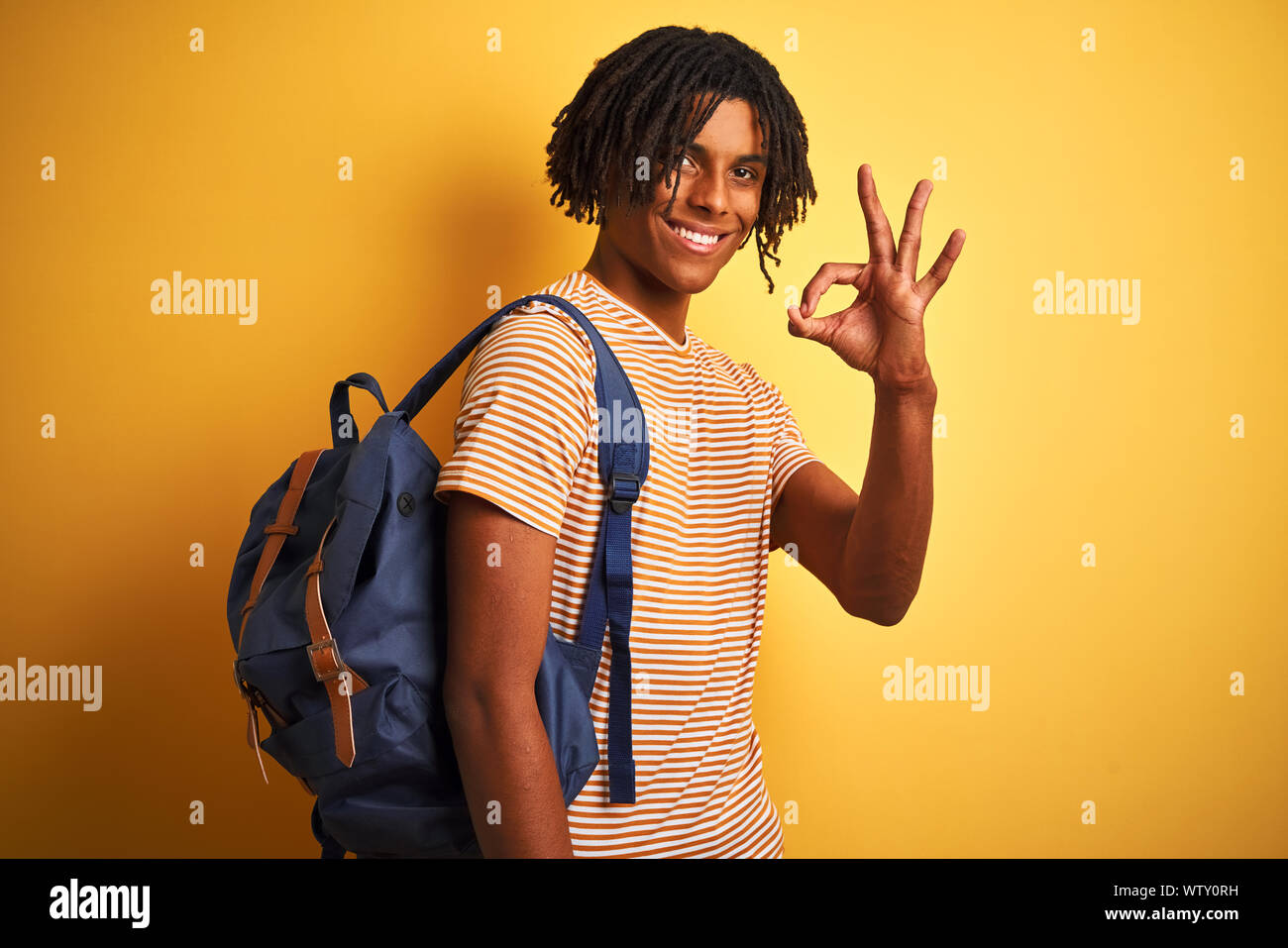 Afro american student man with dreadlocks wearing backpack over ...