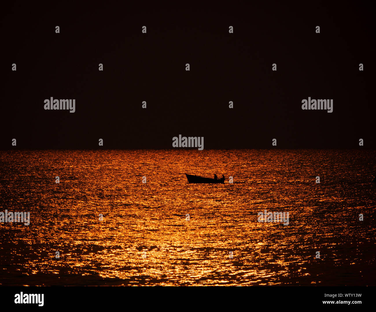 Fisherman boat at sunrise in the lake, high contrast Stock Photo - Alamy