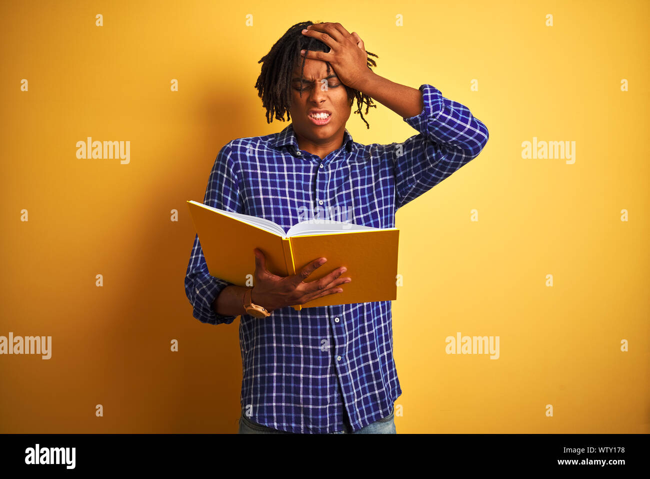 Afro american student man with dreadlocks reading book over isolated ...