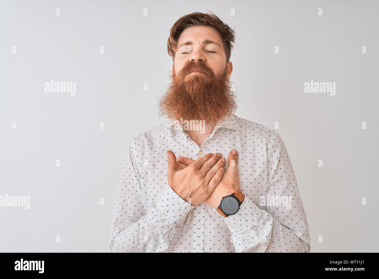 Young redhead irish man wearing shirt standing over isolated white ...