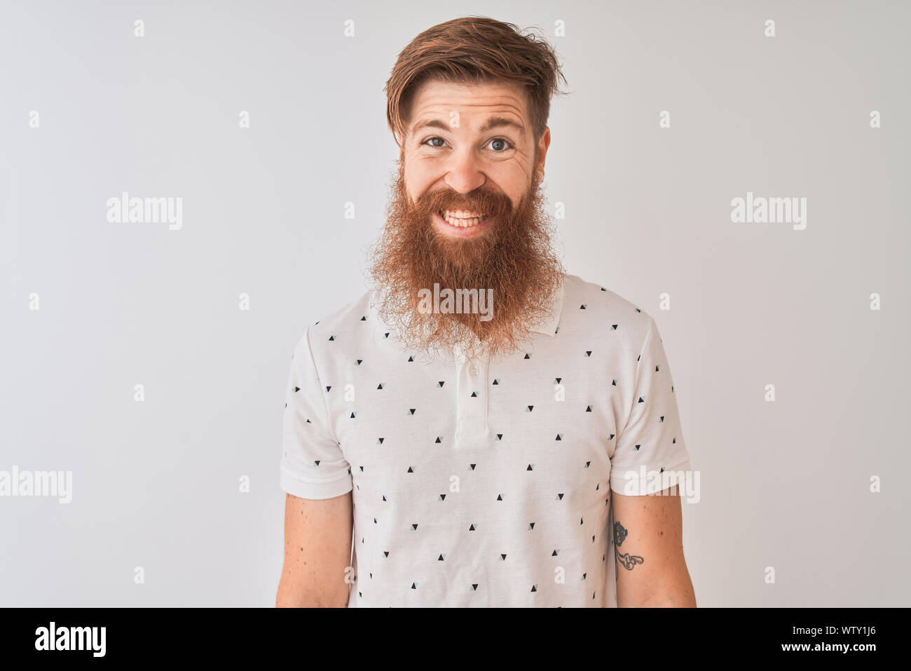 Young redhead irish man wearing polo standing over isolated white ...
