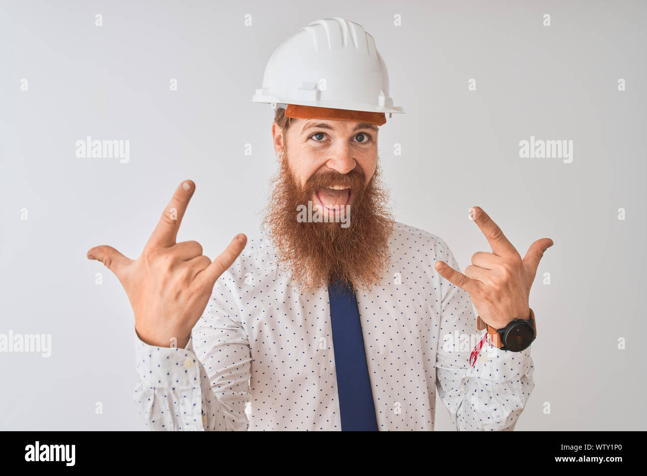 Young redhead irish architect man wearing security helmet over isolated ...