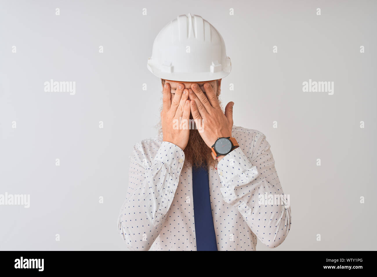 Young redhead irish architect man wearing security helmet over isolated ...