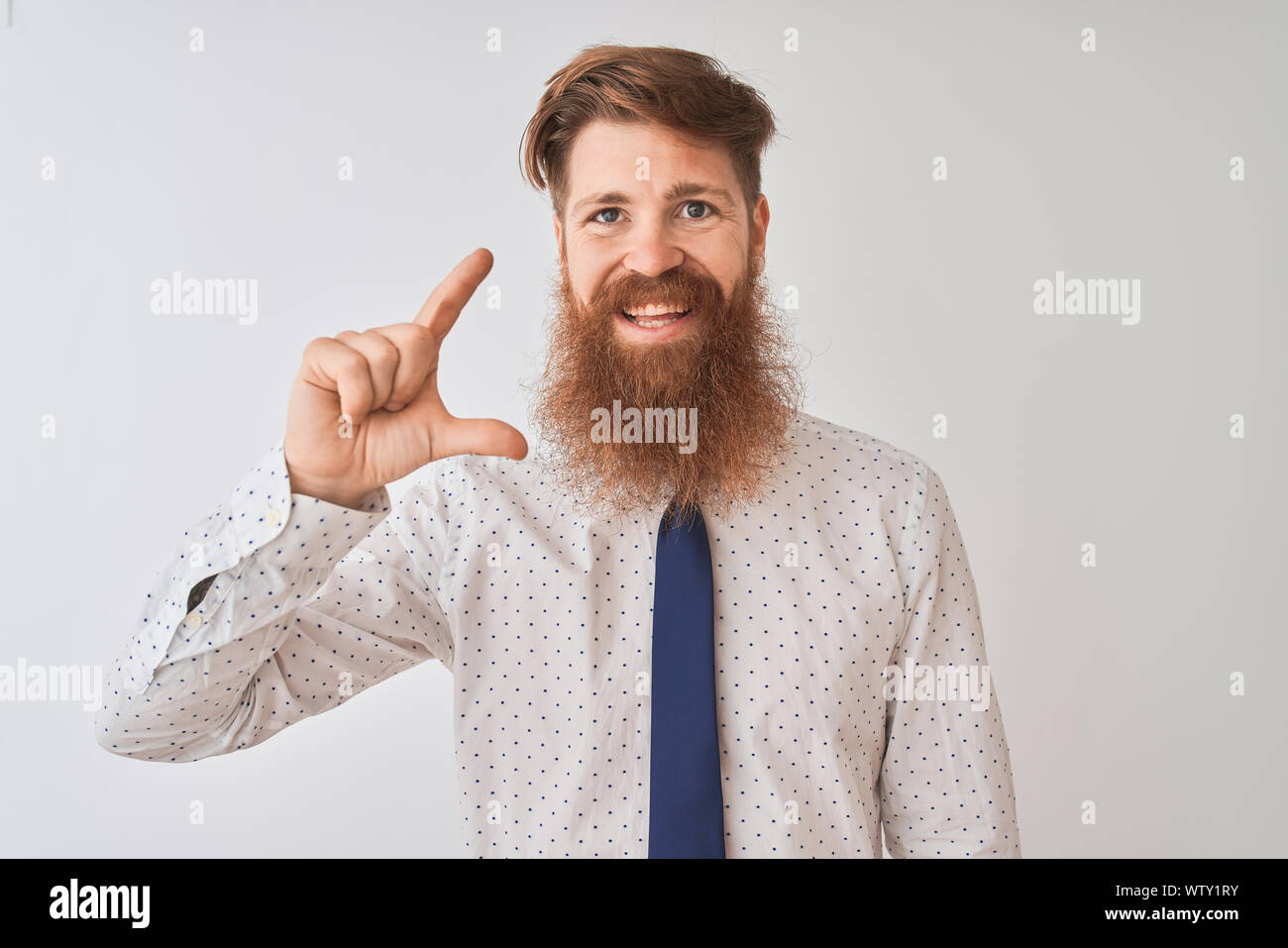 Young redhead irish businessman standing over isolated white background ...