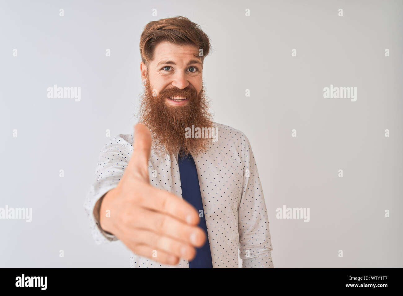 Young redhead irish businessman standing over isolated white background ...