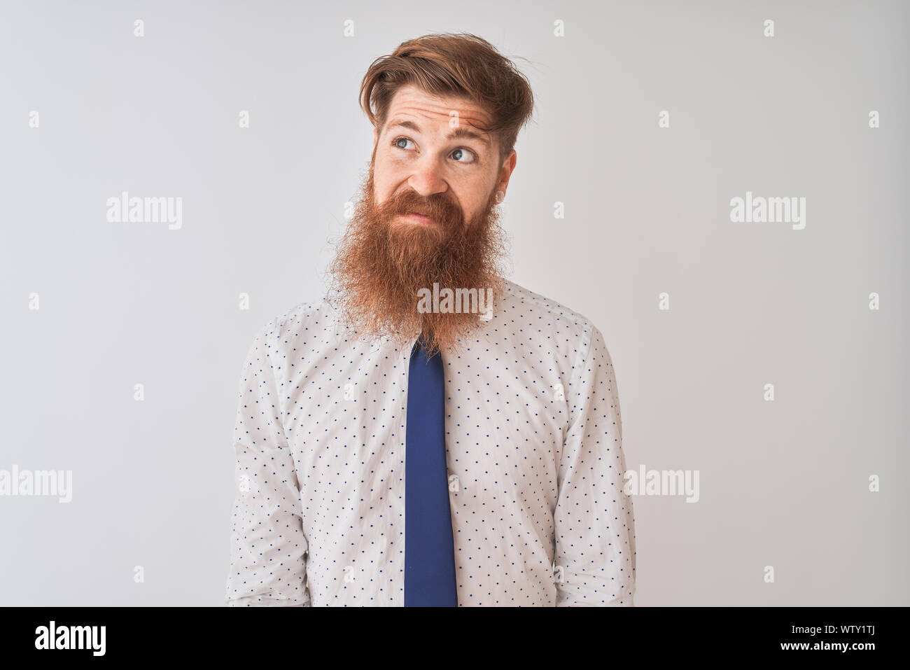Young redhead irish businessman standing over isolated white background ...