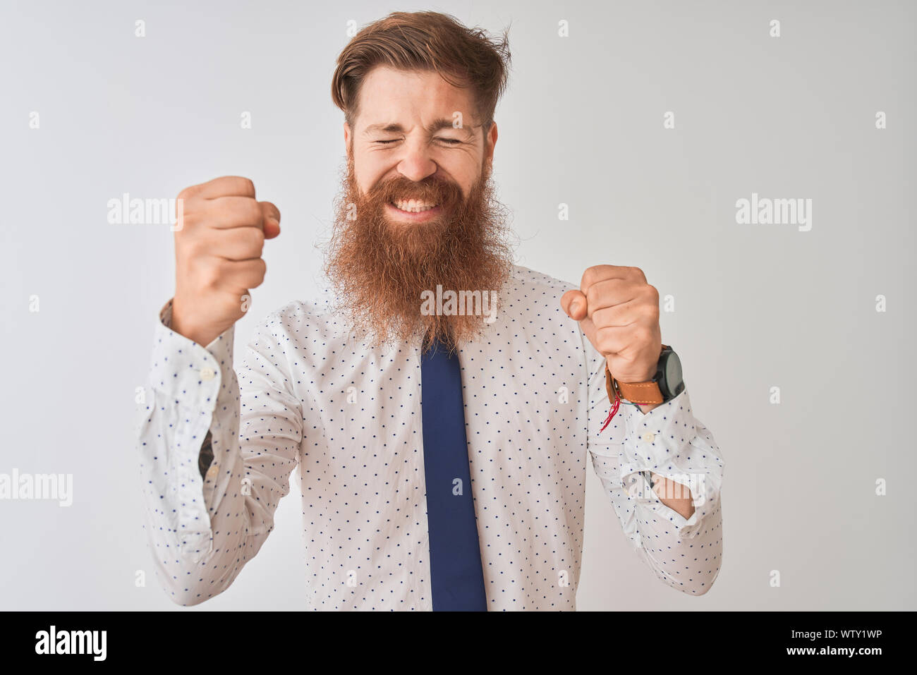Young redhead irish businessman standing over isolated white background ...