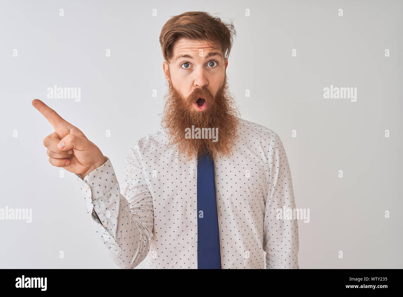 Young redhead irish businessman standing over isolated white background ...