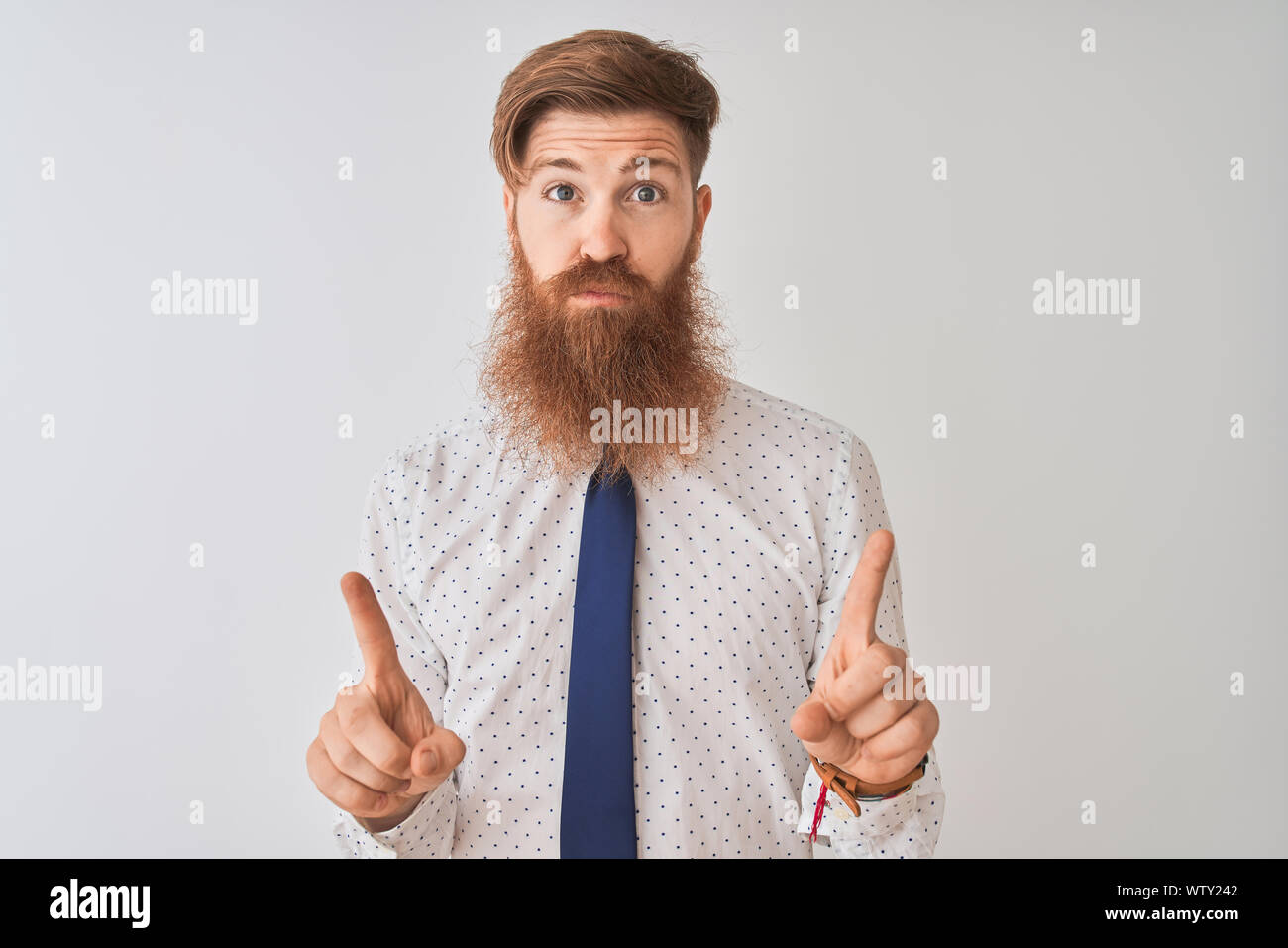 Young redhead irish businessman standing over isolated white background ...