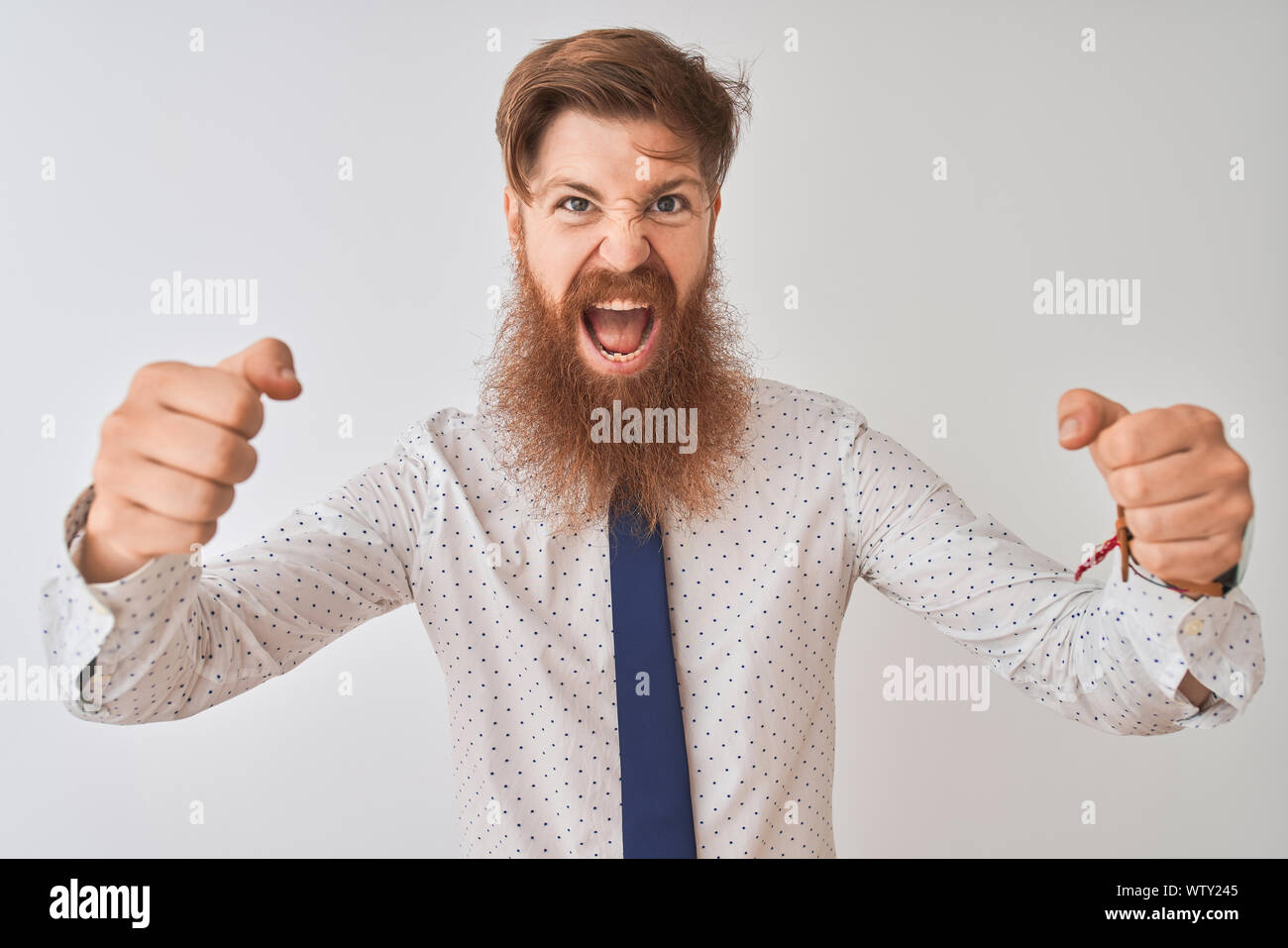 Young redhead irish businessman standing over isolated white background ...